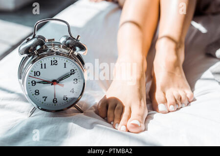 Beautiful female legs and an alarm clock in the morning Stock Photo ...