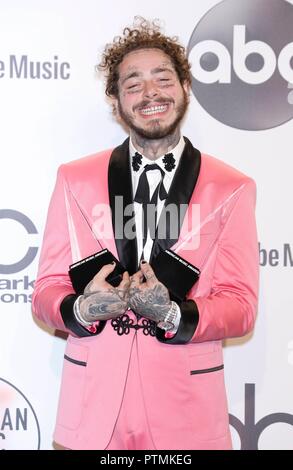 Post Malone poses in the press room during the 2018 American Music ...