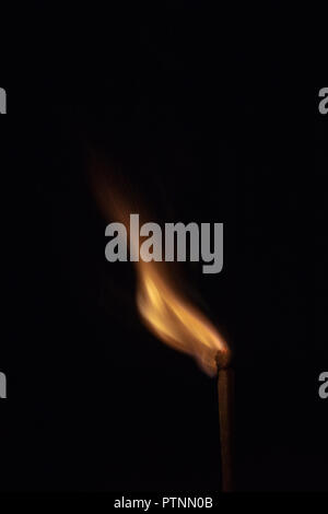 Match with strongly flaring flame on a black background closeup Stock ...