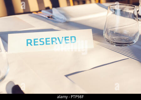 Reservation tag on dining table Stock Photo - Alamy