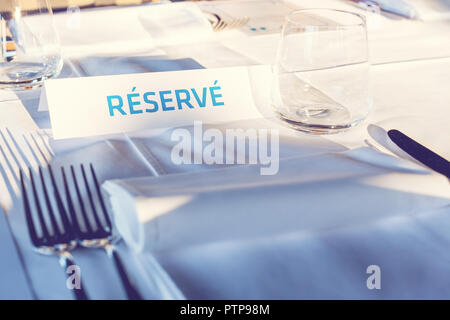A tag of reservation placed on table. Reserved logo in a restaurant or ...