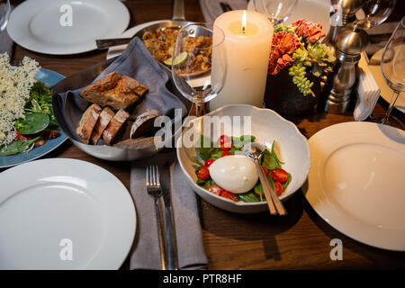 Table setting with salad and baguette Stock Photo - Alamy