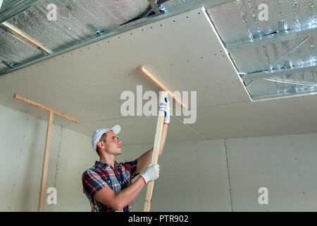 Metal profile for drywall fixing in construction site stacked in ...