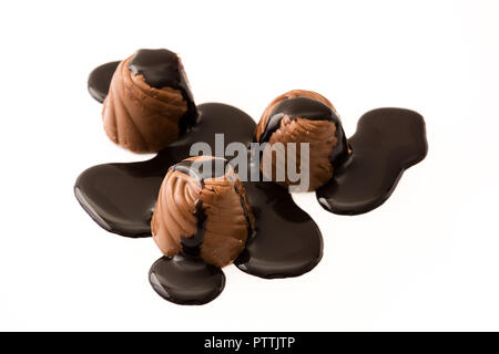 pieces of bonbons covered with melted chocolate background Stock Photo ...