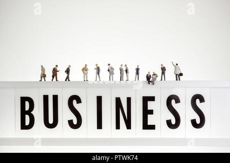 Business word with crowd of miniature business people Stock Photo - Alamy