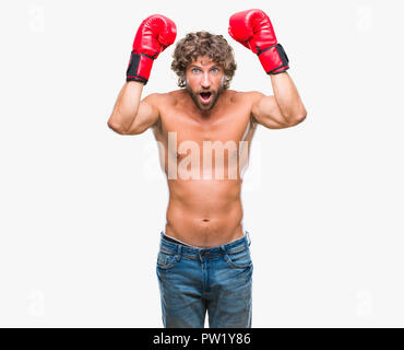 Scared young man boxer in red gloves covered face by hands over yellow ...