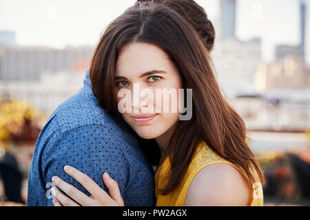 Portrait Of Romantic Couple On Rooftop Terrace With City Skyline In ...