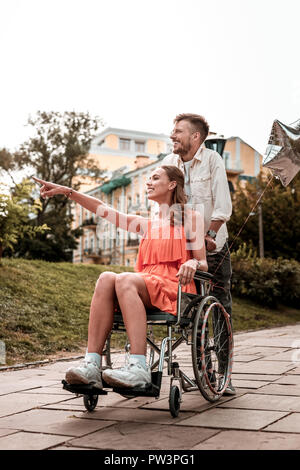 woman in wheelchair pointing into distance Stock Photo - Alamy