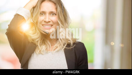 Young woman operator from call center terrified and nervous expressing ...