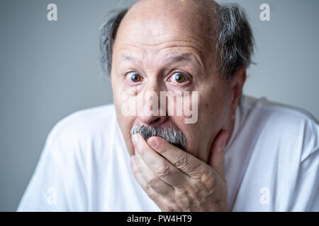 Close up portrait of a scared frightened old man in expression of fear ...
