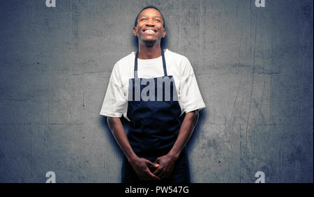 African man shop owner wearing apron happy and excited celebrating ...