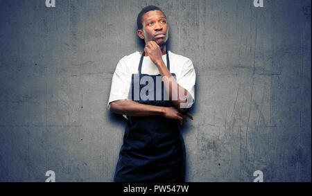 African man shop owner wearing apron happy and excited celebrating ...