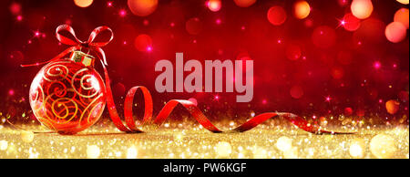 Red Christmas ball with bow on white background Stock Photo - Alamy