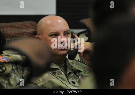 Lt. Col. William Henry, 298th Support Battalion commander, sits on a ...