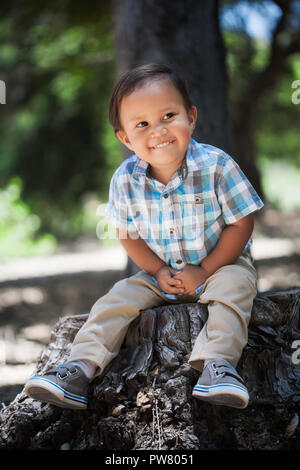 Adorable hispanic toddler sitting on highchair eating food at home ...