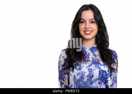 Studio shot of young happy Spanish woman smiling while wearing hat ...