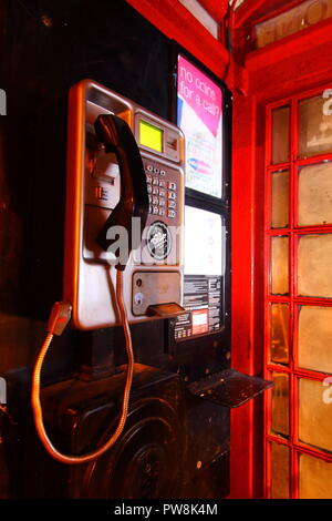 A public telephone inside a BT phone booth england uk Stock Photo ...