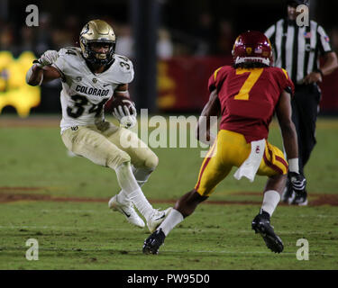 Colorado running back Travon McMillian, right, pulls away from New ...