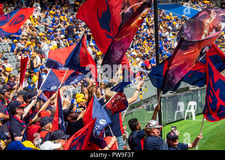 Melbourne Demons Football Club cheer squad waving flags and banners at ...