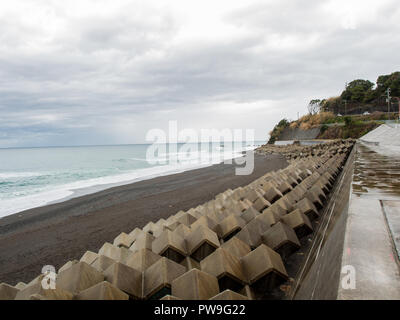 Tetrapods lining concrete sea wall, the curve of the coast, a tetrapod ...