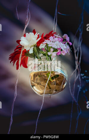 Herbal tea bottle with flowers hanging on string Stock Photo - Alamy