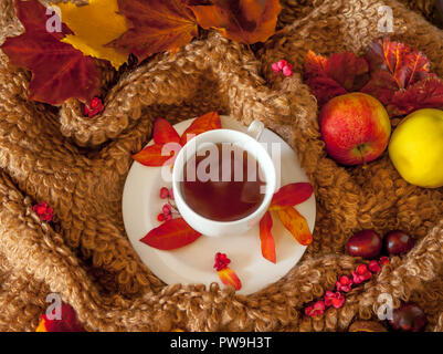A cup of tea and apples with maple leaves. Autumn tea party, autumn ...