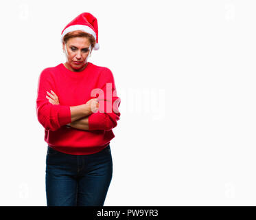 Redhead woman wearing santa claus hat stressed with hand on head ...
