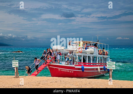 Tourist boat arriving at Megalos Aselinos beach, at the north coast of ...