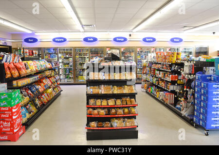 Interior of generic convenience market with aisles of snack foods and ...