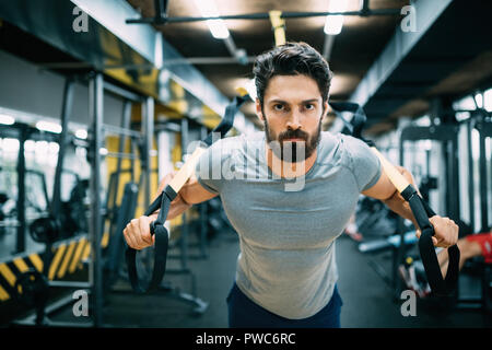 Caucasian man exercising with suspension training trx Stock Photo - Alamy