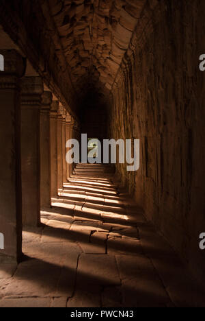 Arcade in a temple close to Angkor Wat in Cambodia with the morning sun ...