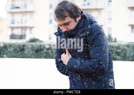 Shivering man in snow storm Stock Photo - Alamy