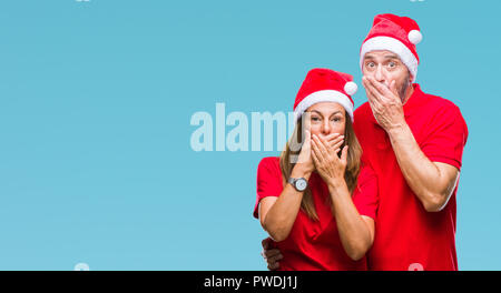 Middle age hispanic couple wearing christmas hat over isolated ...