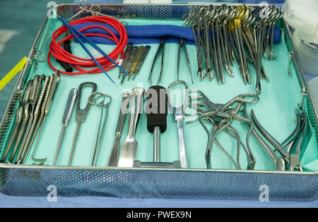 Surgical equipment laid out on a tray in a hospital operating theatre ...