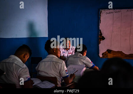 teacher helping students in guatemalan college Stock Photo - Alamy