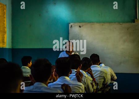 teacher helping students in guatemalan college Stock Photo - Alamy
