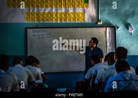 teacher helping students in guatemalan college Stock Photo - Alamy