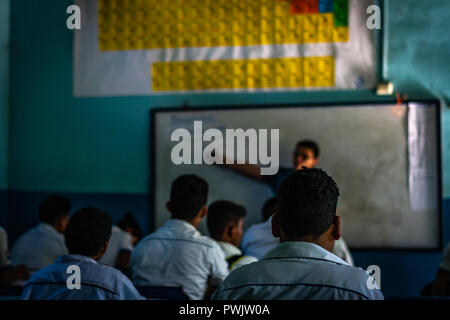 teacher helping students in guatemalan college Stock Photo - Alamy