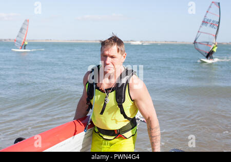 Man carrying paddle board Stock Photo - Alamy