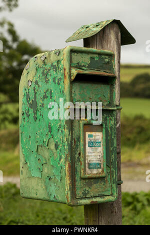 A traditional green Irish post box standing alone on a quiet Dublin ...