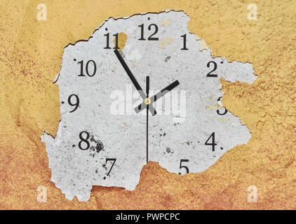 Clock on a yellow wall showing 1:55 o'clock Stock Photo - Alamy