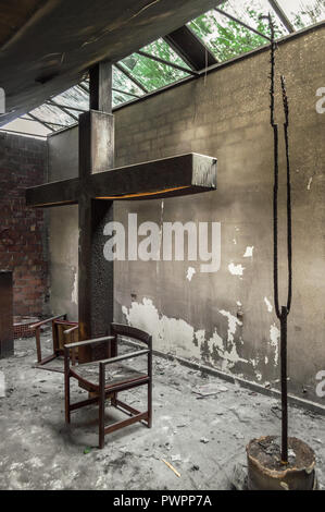 Cross in a burned and devastated church after the disturbances in ...