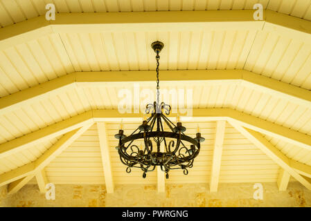1-light metal chandelier under the ceiling made of bamboo and garland ...