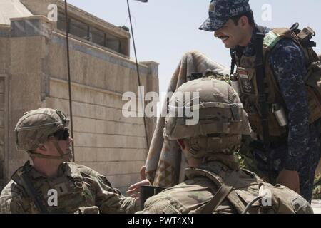 Iraqi police and U.S. Army work together in Iraqi village Stock Photo ...