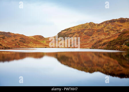 Beacon Tarn in the Blawith Fells with the snow covered "Old Man of ...