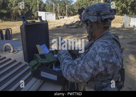 U.S. Army Spc. Justin Farfan assembles a Joint Chemical Agent Detector ...