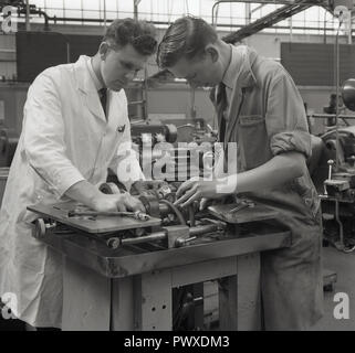 1960s, historical, a young male apprentice showing local councilors the ...