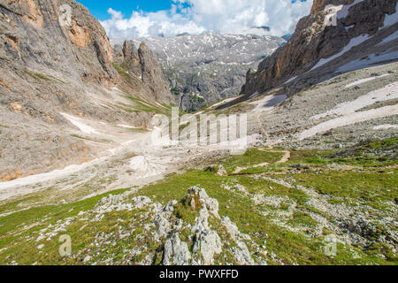 An aerial view of steep rocky mountains with green trees and forests ...