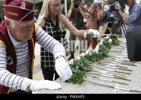 Task Force Smith’s war veteran places one flower on the memorial at the ...