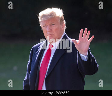 President Donald Trump waves as he prepares to board Air Force One at ...